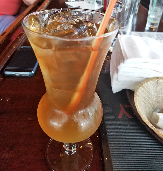 Cool down with a refreshing iced tea served in a tall glass – the perfect companion to the hearty comfort food offerings.