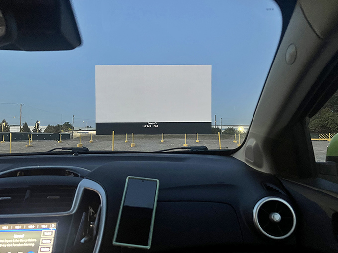 The view from inside your vehicle frames the massive screen, creating your personal cinema under the open sky.