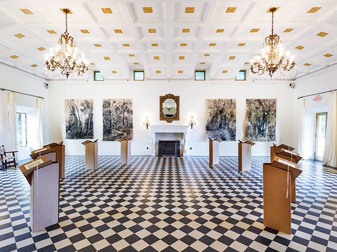 This elegant interior space speaks volumes about 1920s sophistication, where chandeliers and coffered ceilings frame gatherings both past and present.