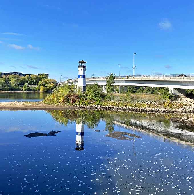 Mirror-like waters double the visual impact, reflecting the lighthouse in perfect symmetry on calm Mississippi mornings.