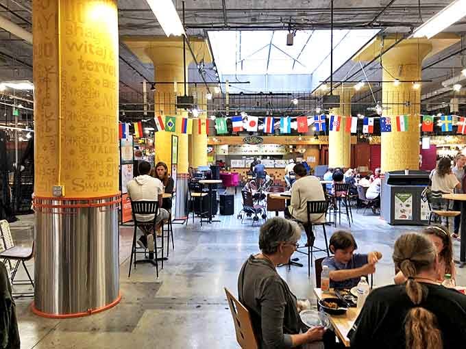 The communal seating area buzzes with conversation as strangers become friends over shared plates and food recommendations.