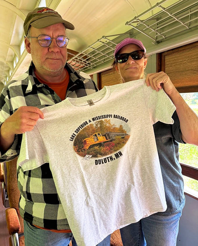 Proud travelers display their railroad souvenirs &ndash; tangible memories of an intangible experience through Minnesota's northern wilderness.