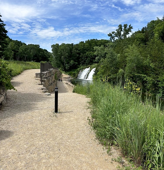 The pathway offers tantalizing glimpses of the falls ahead, building anticipation with every step like nature's own teaser trailer.