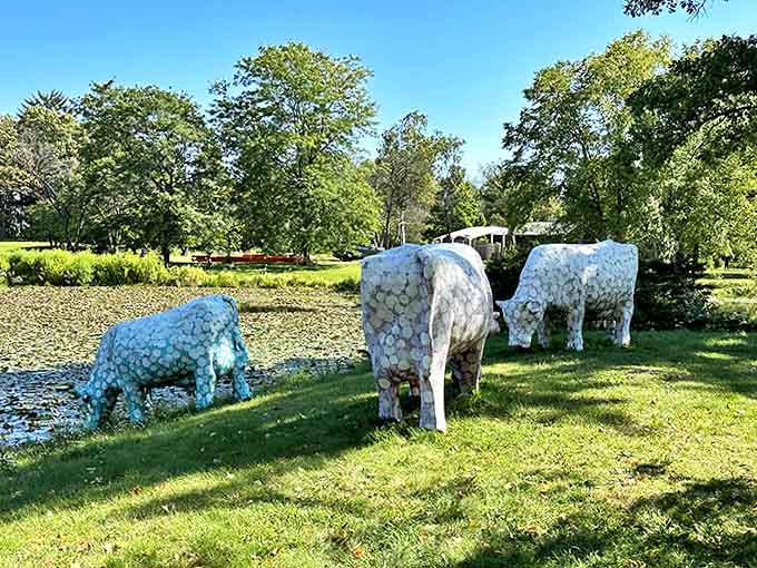 These patterned bovines graze peacefully by the pond, their mosaic-like surfaces catching sunlight like stained glass windows.