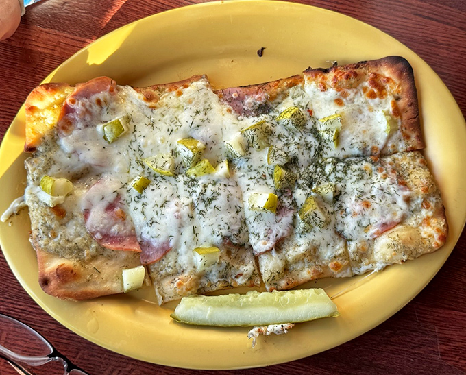 The flatbread pizza showcases how pickles can elevate unexpected dishes, with melty cheese and savory toppings creating perfect harmony.