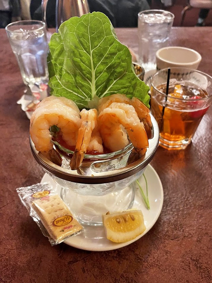 Plump shrimp perched on a glass pedestal, surrounded by ice &ndash; seafood cocktail served with the same presentation your grandparents enjoyed.