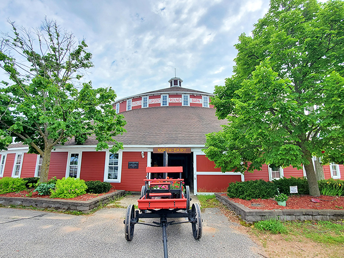 A vintage wagon parked outside hints at the barn's historical significance in Wisconsin's agricultural story &ndash; old meets older.