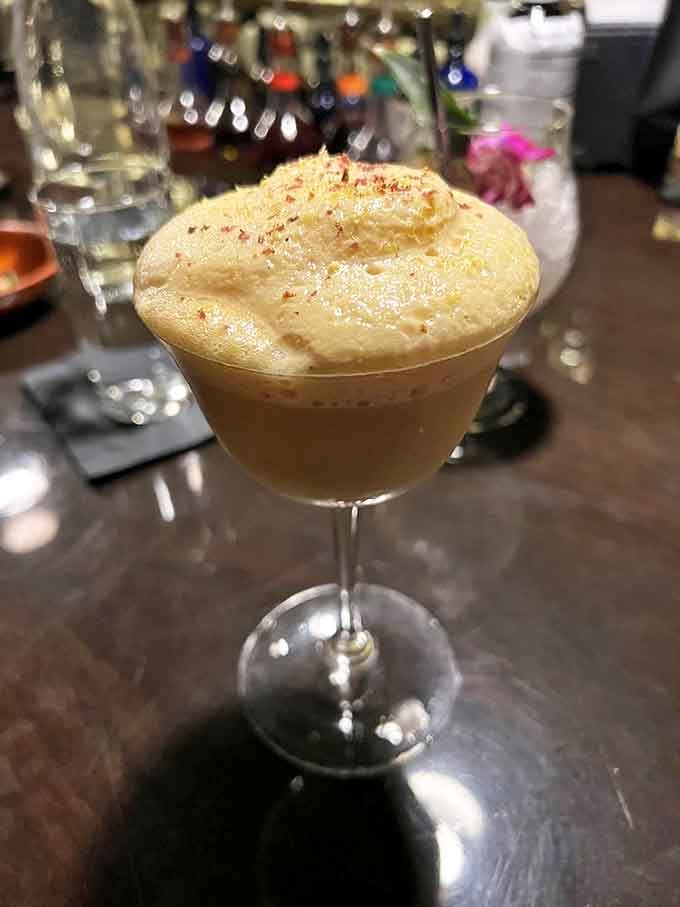 Rye Me A River: This golden elixir with its perfect foam cap isn't just a drink &ndash; it's liquid sunshine with hints of spice that warm you from the inside out.