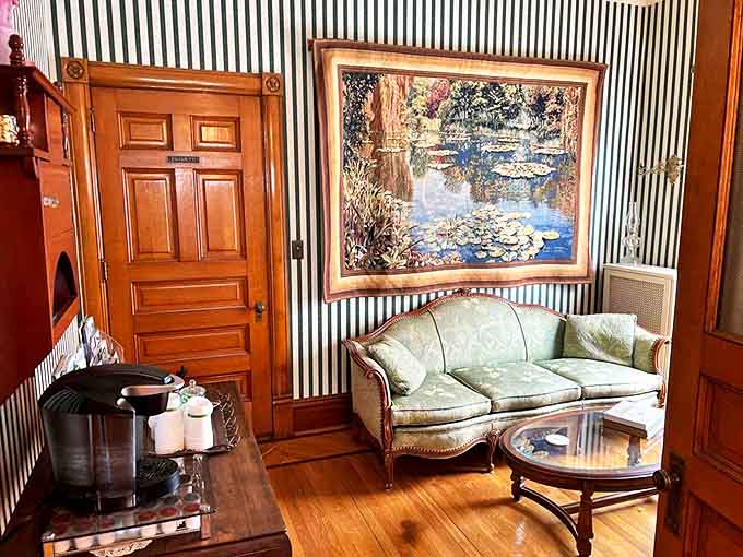 Striped wallpaper and period furnishings create a sitting room where you'll actually want to sit, perhaps plotting your next small-town adventure.