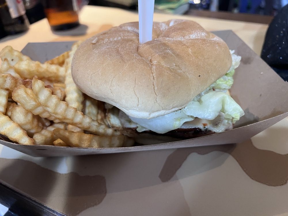 A classic burger and waffle fries served on military-themed placemats &ndash; casual dining with a side of historical appreciation.
