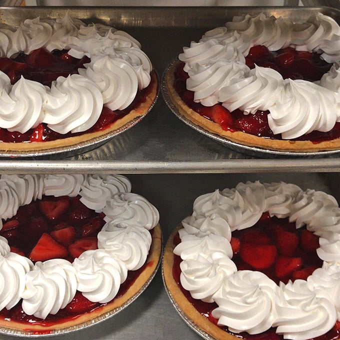 Fresh strawberry pies crowned with fluffy swirls of cream, waiting to be the day&rsquo;s sweetest highlight.