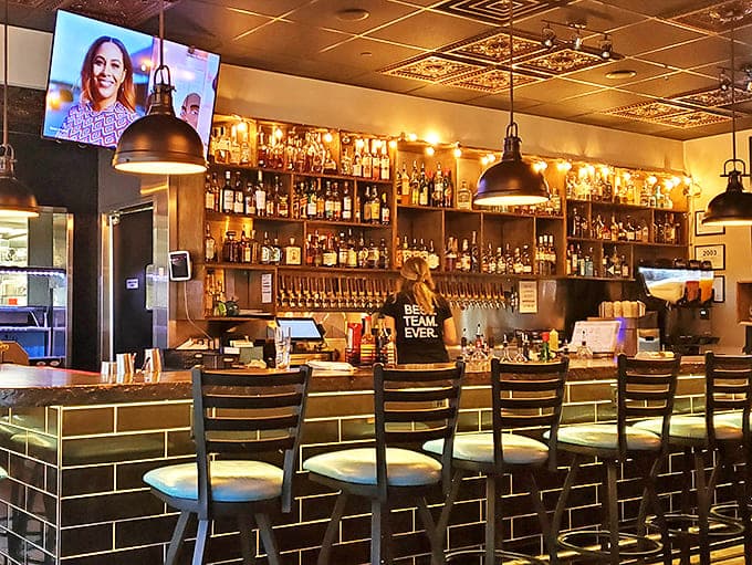 A bar stocked for serious business, where bottles gleam like treasures and the bartenders mix drinks with the precision of scientists.