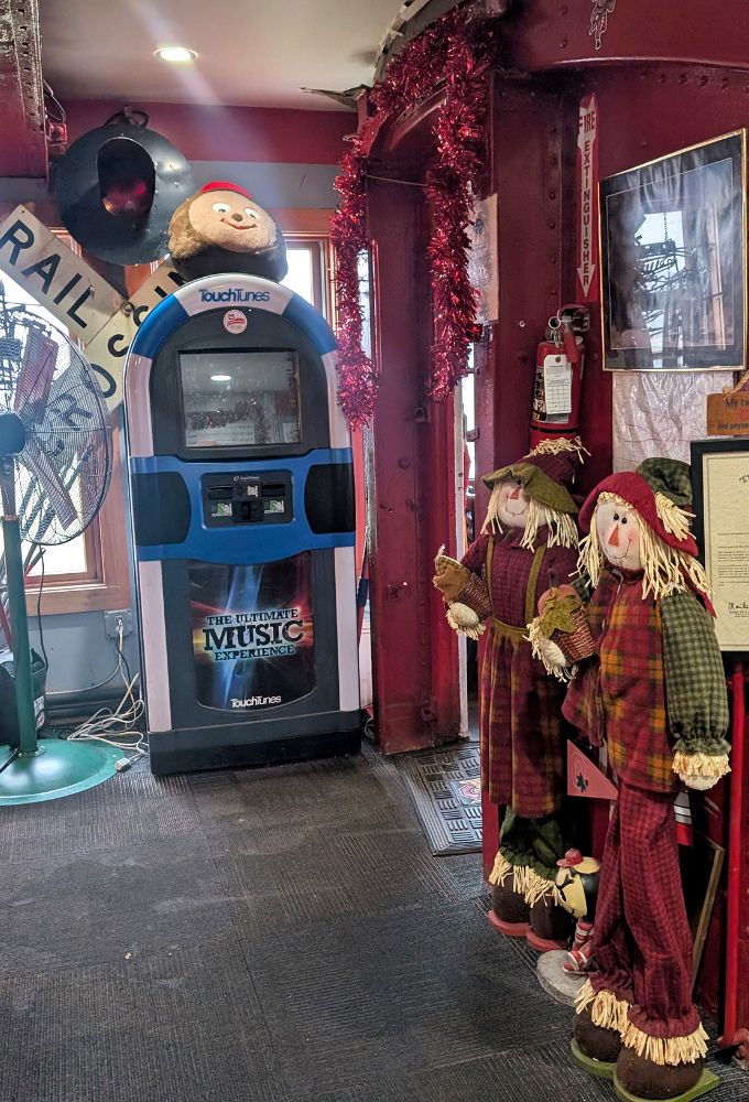 The TouchTunes jukebox stands ready to provide a soundtrack for your meal, while holiday decorations add festive charm.