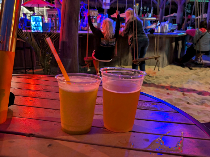 Two golden elixirs catching the bar lights, patiently waiting to transform ordinary conversations into memorable vacation stories.