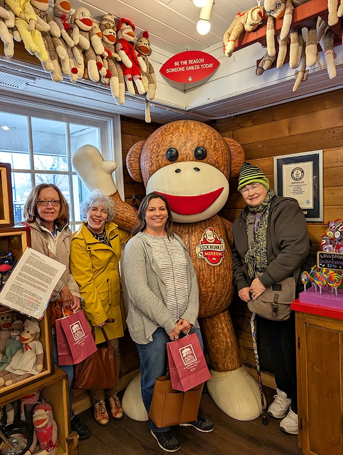 Happy visitors pose with the museum's giant mascot, creating memories as unique as the handcrafted creatures surrounding them.