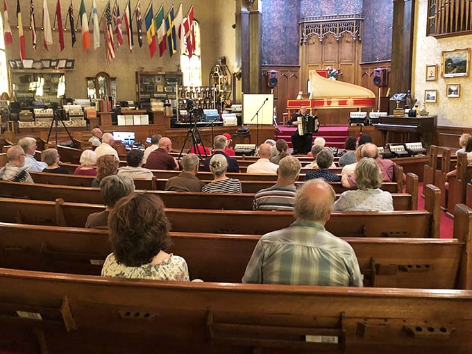 In this former church sanctuary, visitors gather for an intimate accordion performance surrounded by musical history.