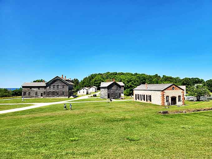 Buildings arranged like a historical diorama, each structure telling part of Fayette's story against the backdrop of Michigan's pristine waters.