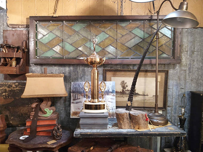 This vignette of vintage treasures combines stained glass, antique lighting, and weathered wood &ndash; the perfect ingredients for adding character to a modern home.