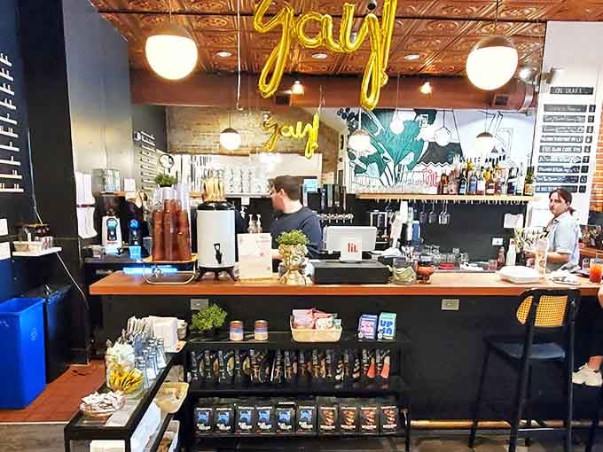 Playful "yay" balloons hover above the bar where baristas and bartenders craft beverages worthy of pairing with your next literary adventure.
