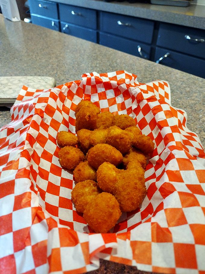 Golden cheese curds nestled in checkered paper, Wisconsin's favorite appetizer done to crispy, melty perfection.