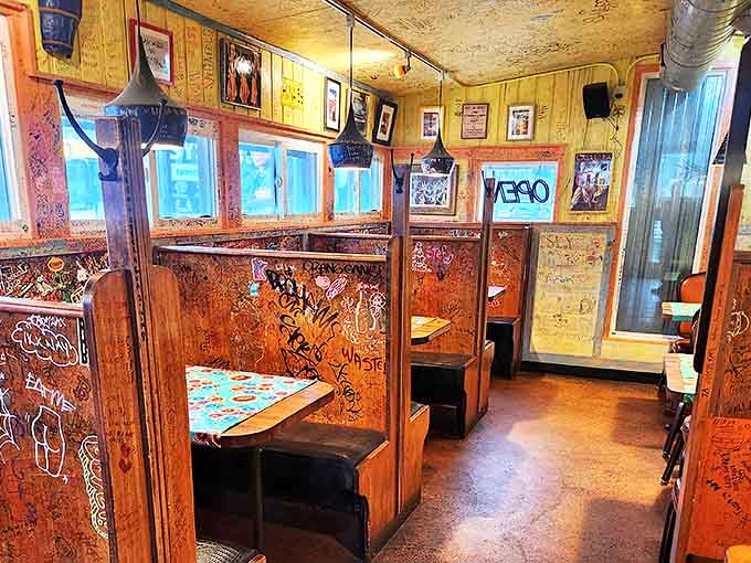 Cozy wooden booths create intimate dining spaces where conversations flow as freely as the Cuban coffee, all under exposed ductwork that's seen it all.