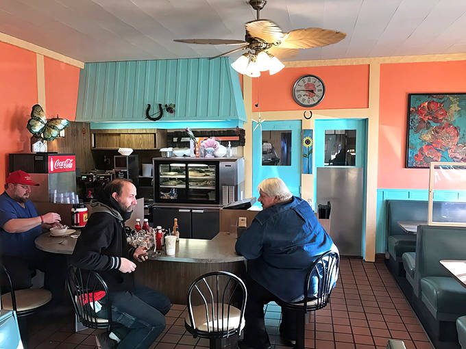 The coral and turquoise color scheme creates a cheerful backdrop for serious eating &ndash; where calories don't count and coffee cups stay full.