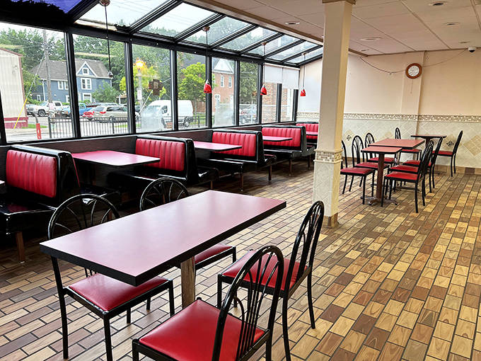 Red booths and simple tables create a cozy atmosphere where you'll want to linger over every delicious bite.