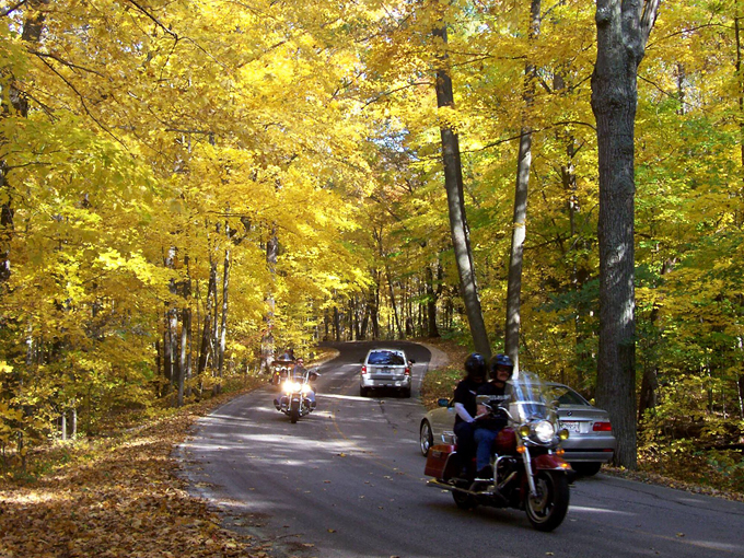 The road curves ahead like a promise – each bend revealing another chapter in Wisconsin's glacial story.