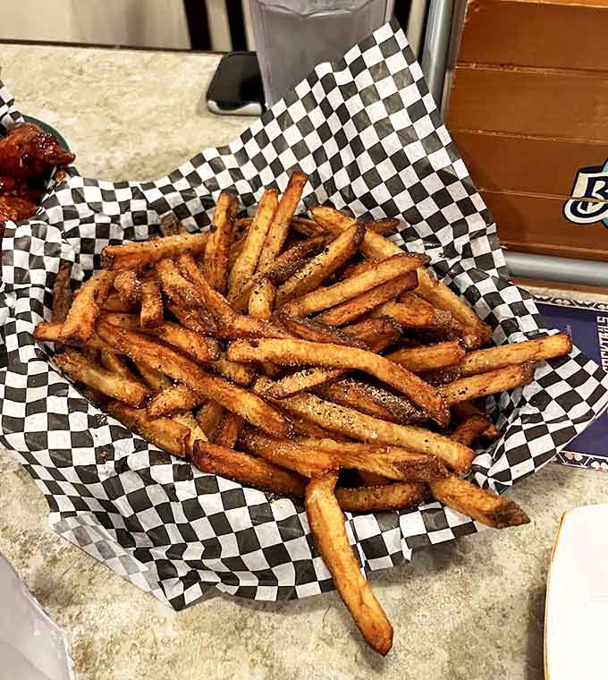 Hand-cut fries seasoned with what must be a secret blend of spices or perhaps just decades of accumulated flavor wisdom.