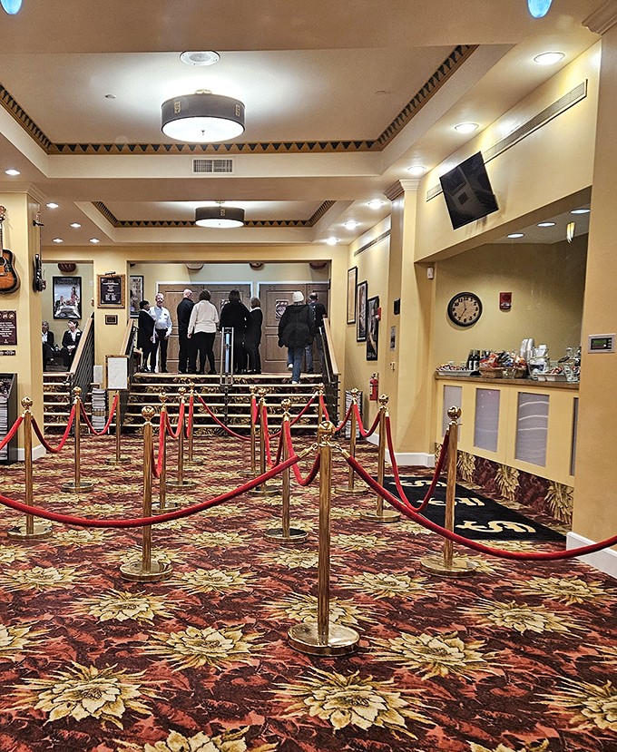 The elegant lobby with its velvet ropes creates an atmosphere of anticipation, guiding guests toward an evening of cultural enrichment.