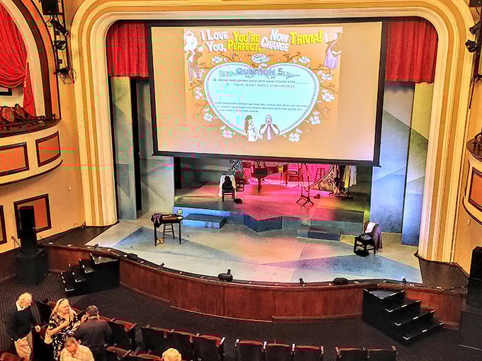 Inside the auditorium, elegant arches frame the stage while chandeliers illuminate a space where community and culture have intersected for nearly a century.