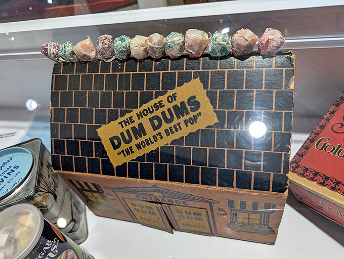 Vintage Dum Dums packaging showcases "The World's Best Pop" in its original brick-patterned box, a nostalgic glimpse into candy history.