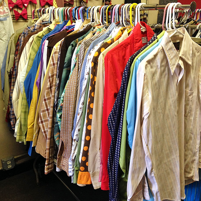 A kaleidoscope of vintage shirts hangs in chromatic harmony &ndash; each one a time capsule of an era when collars were wide and patterns were wider.
