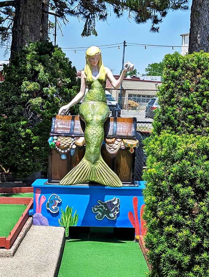 The mermaid presides over her underwater kingdom, her treasure chest and golden locks adding mythical magic to this maritime mini-golf adventure.