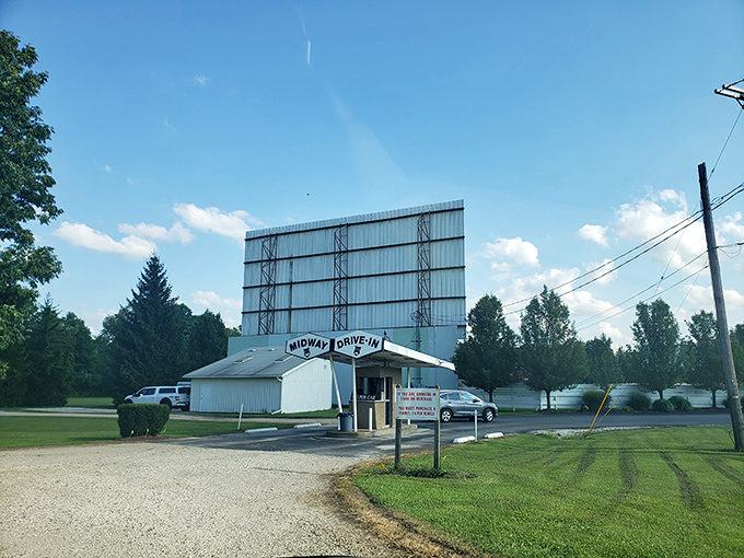 As twilight fades to darkness, cars arrange themselves like puzzle pieces, each with perfect views of cinematic adventures ahead.