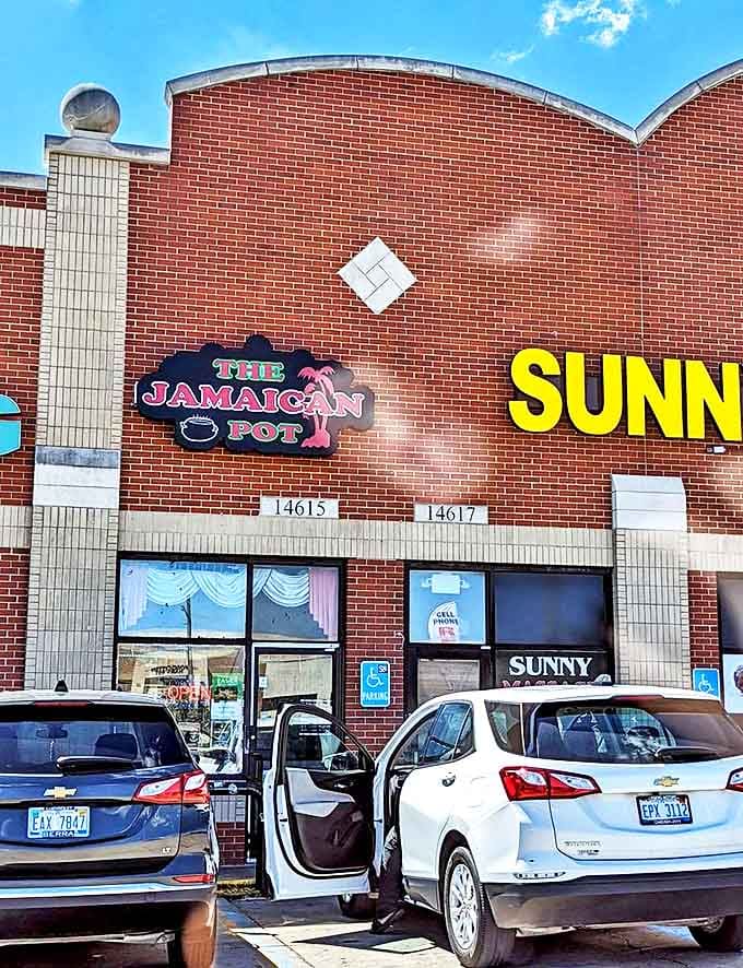 The Jamaican Pot's exterior might be humble, but the bold sign promises extraordinary flavors waiting just beyond those unassuming doors.