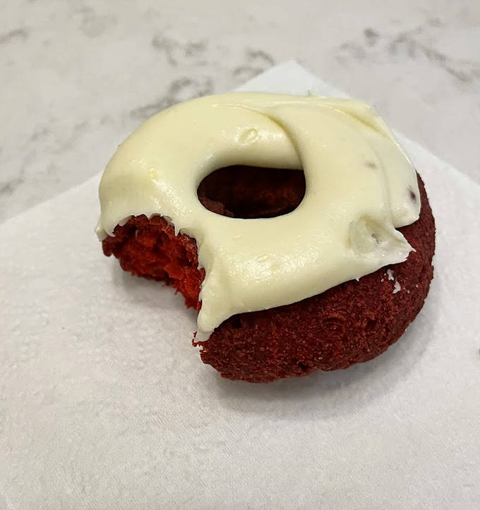Red velvet's deep crimson crumb peeks through cream cheese frosting, proving some relationships (like chocolate and tangy cream cheese) are simply meant to be.