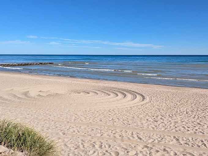Morning light reveals pristine sand waiting for the day's footprints, beach artists, and sandcastle architects.