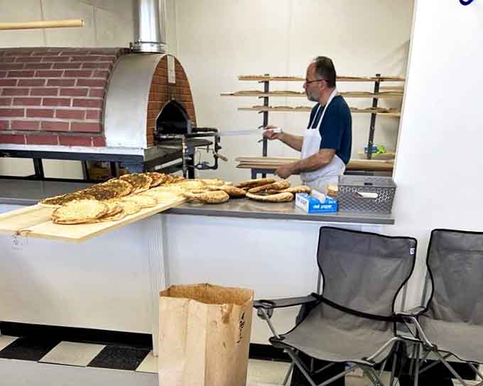 The master at work, tending the brick oven where flatbreads transform from mere dough to transcendent taste experiences.