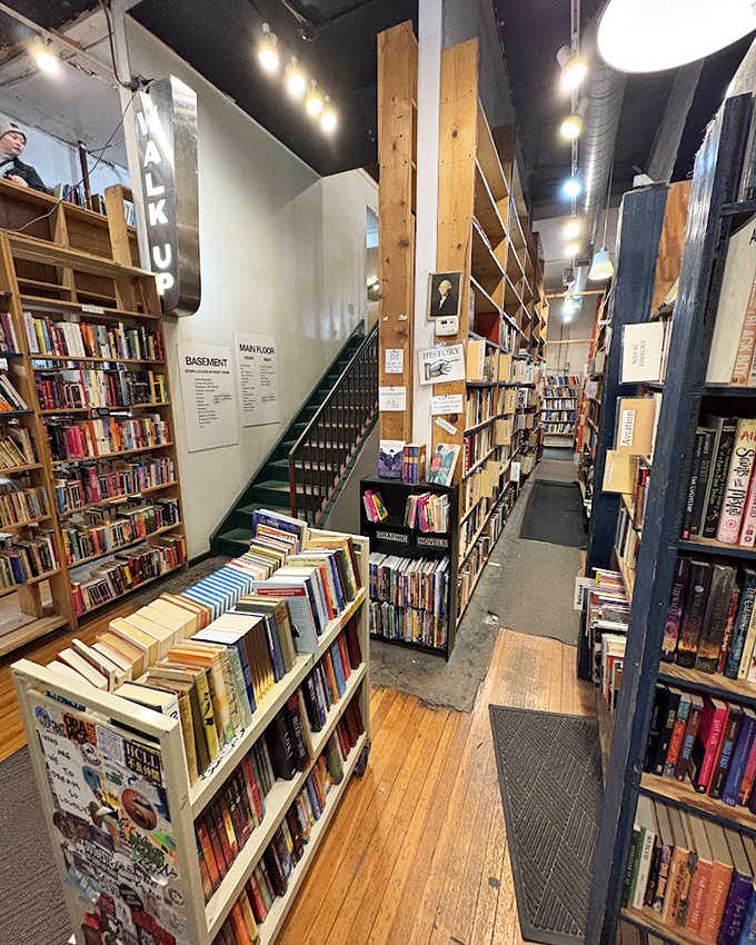 The stairwell area serves as a transition zone between literary worlds, each level offering its own unique atmosphere and selection.