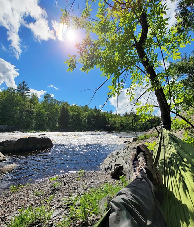 A hammock hangs by the riverbank &ndash; proof that sometimes the best hiking activity is not hiking at all.