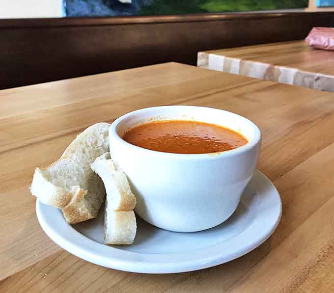 This tomato soup isn't just a side &ndash; it's a main character in its own culinary story, with bread chunks playing the perfect supporting role.