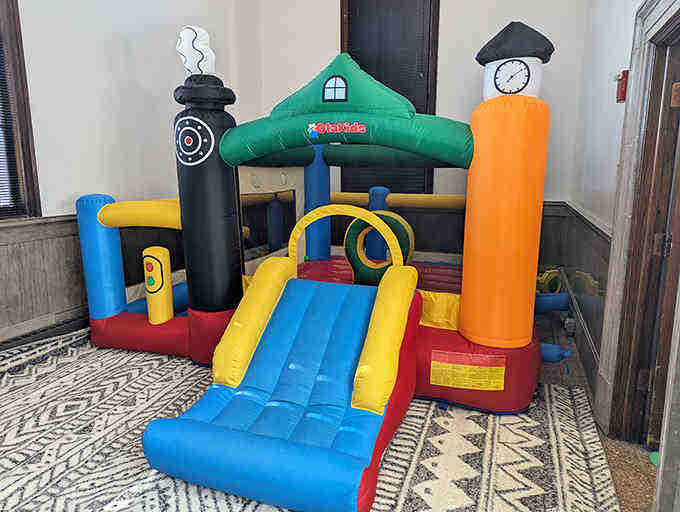 The train-themed bounce house offers the perfect pit stop for energetic conductors to blow off steam before returning to more focused play.