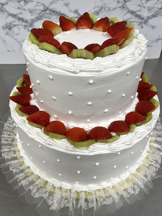 This two-tiered beauty adorned with fresh strawberries and kiwi slices transforms any celebration from ordinary to extraordinary in an instant.