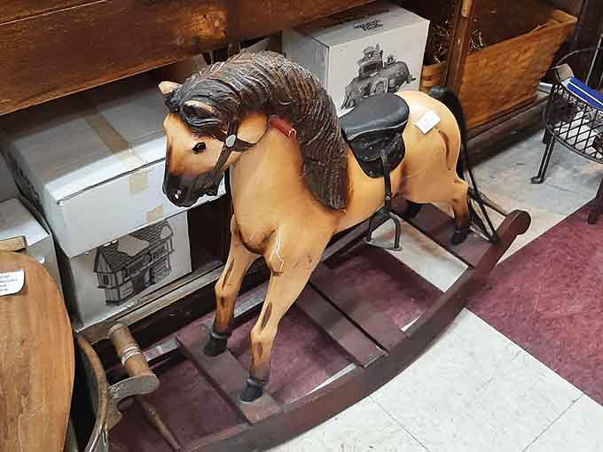 This wooden rocking horse has galloped through decades, its worn paint revealing where countless small hands once held tight.