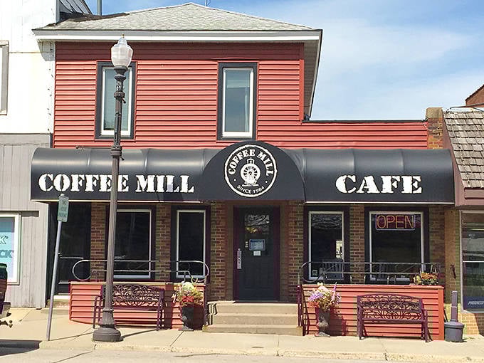 Meister's rustic wooden exterior beckons hungry travelers with its vertical red sign and charming patio &ndash; a roadside oasis of culinary delight.