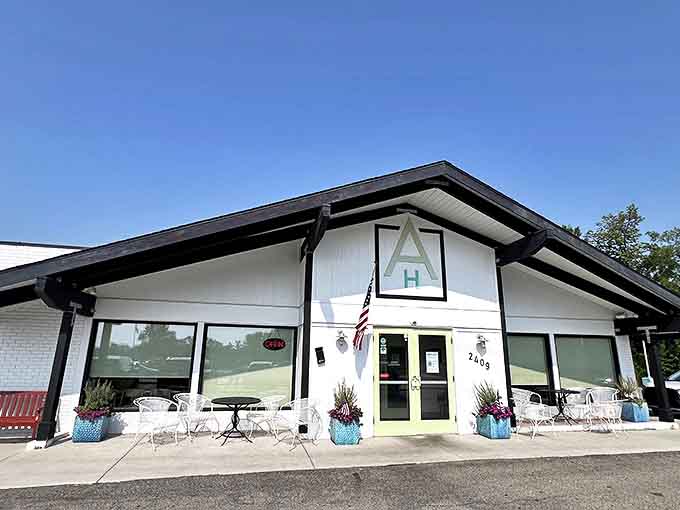 The charming exterior of Anna's House welcomes guests with its distinctive turquoise accents and inviting patio seating &ndash; breakfast paradise awaits inside!