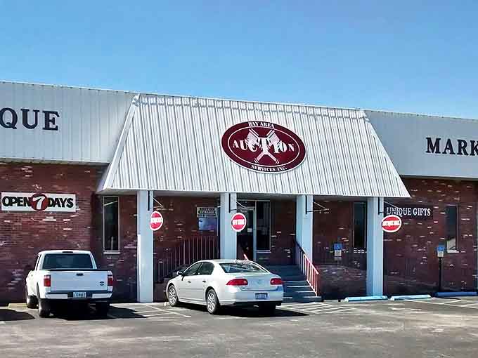 The unassuming white facade of Palmetto Auction hides a universe of vintage treasures, like a poker player concealing a royal flush.