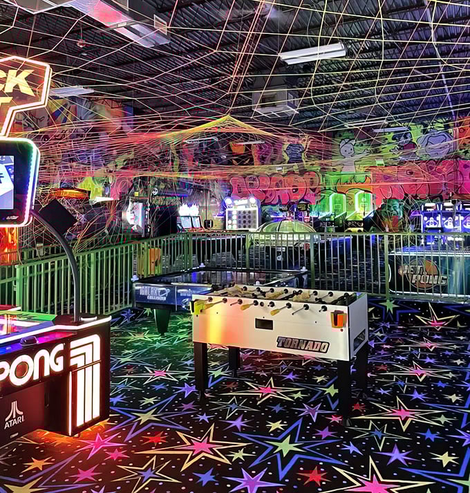 Step into a neon dreamscape where the ceiling dances with colorful string lights and the floor sparkles with stars. Gaming paradise found!