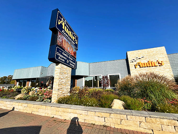 The iconic blue sign welcomes hungry travelers, promising Great Lakes comfort beneath the shadow of the Mackinac Bridge.
